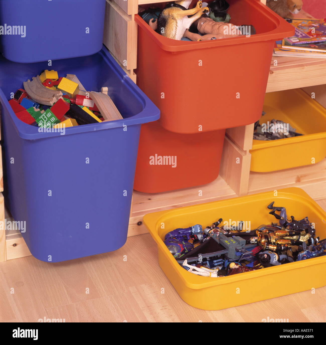 Close-up of red, blue and yellow plastic storage boxes with children's ...