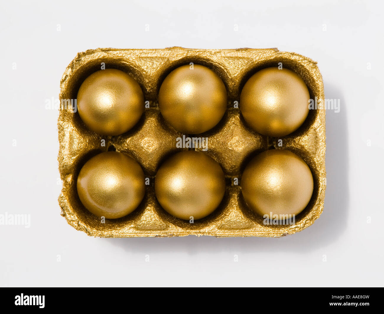 Golden eggs in an egg box Stock Photo - Alamy