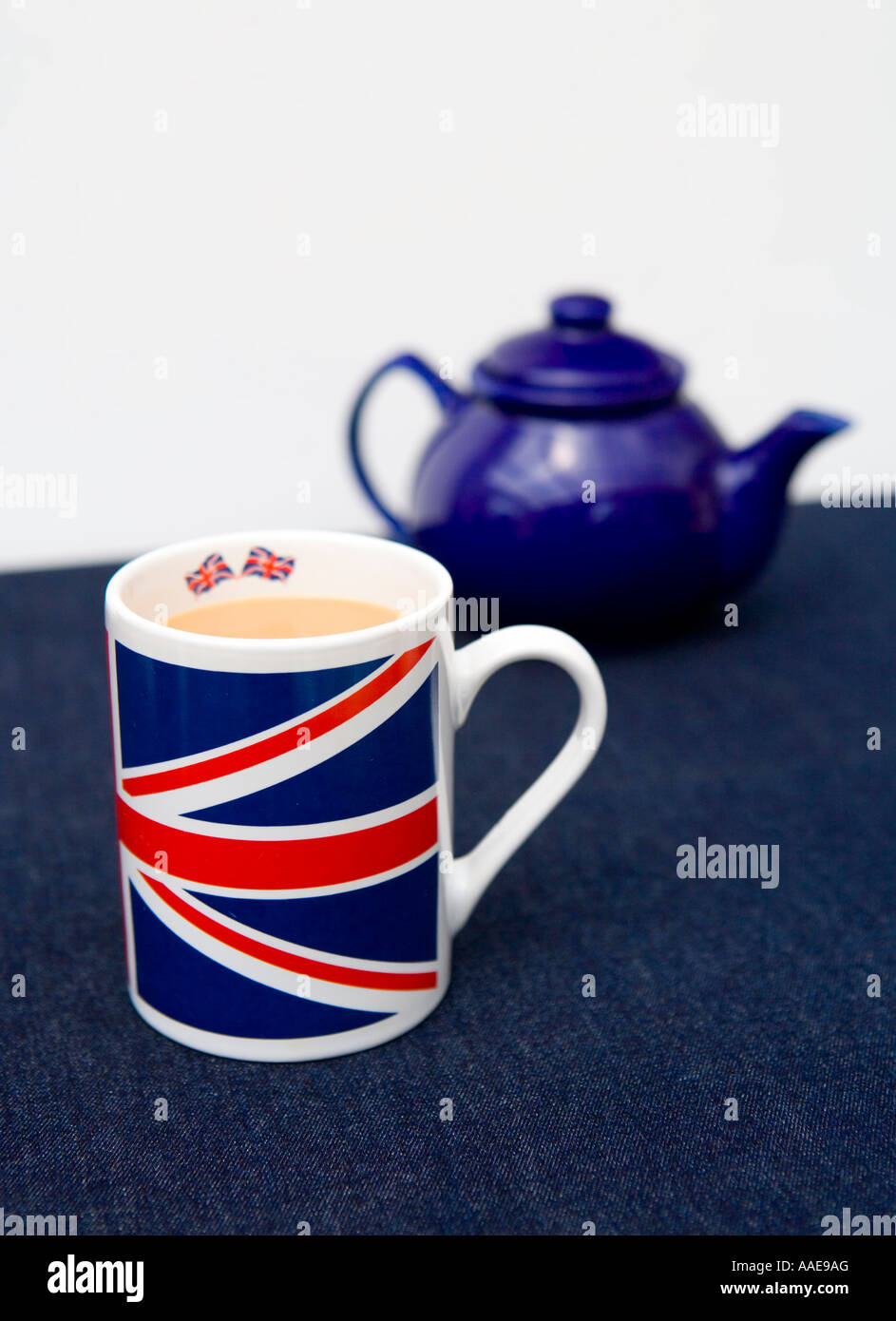 An British union jack mug of tea with blue teapot Stock Photo - Alamy