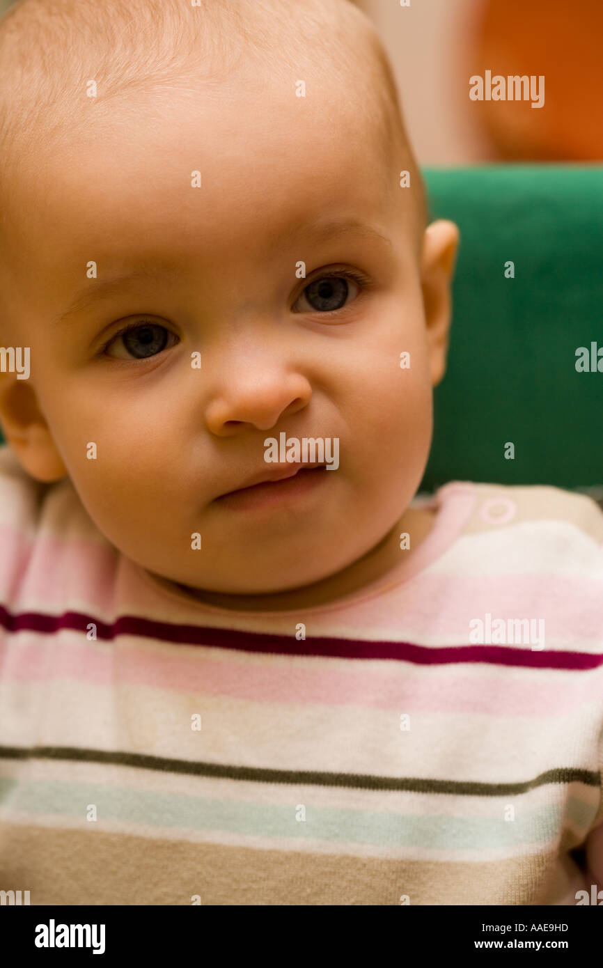 Bored Baby Girl at 10 months in her new play pen - not too happy Stock ...