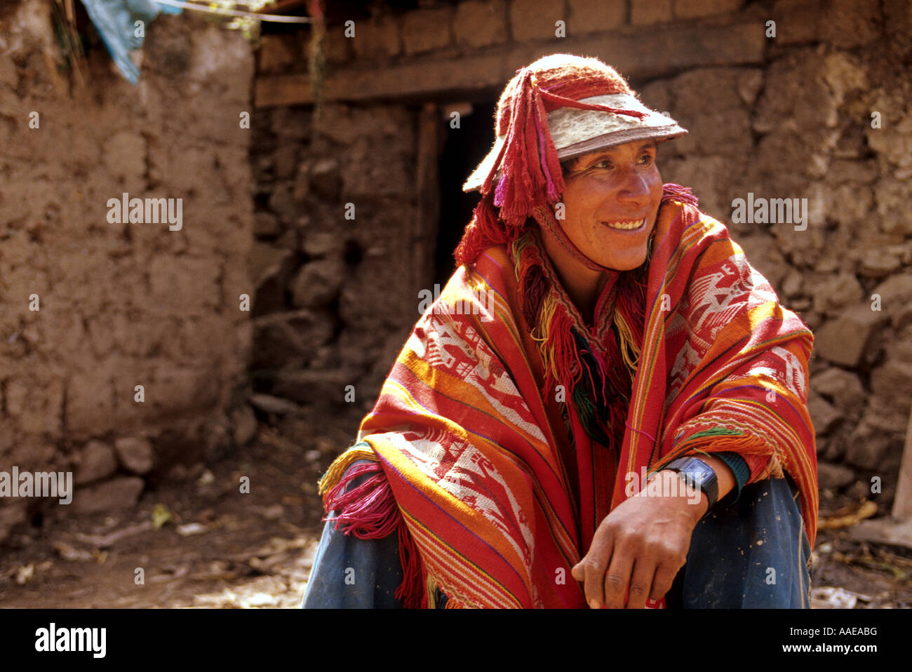 Traditionally dressed Quechua indian sitting in small village in the ...