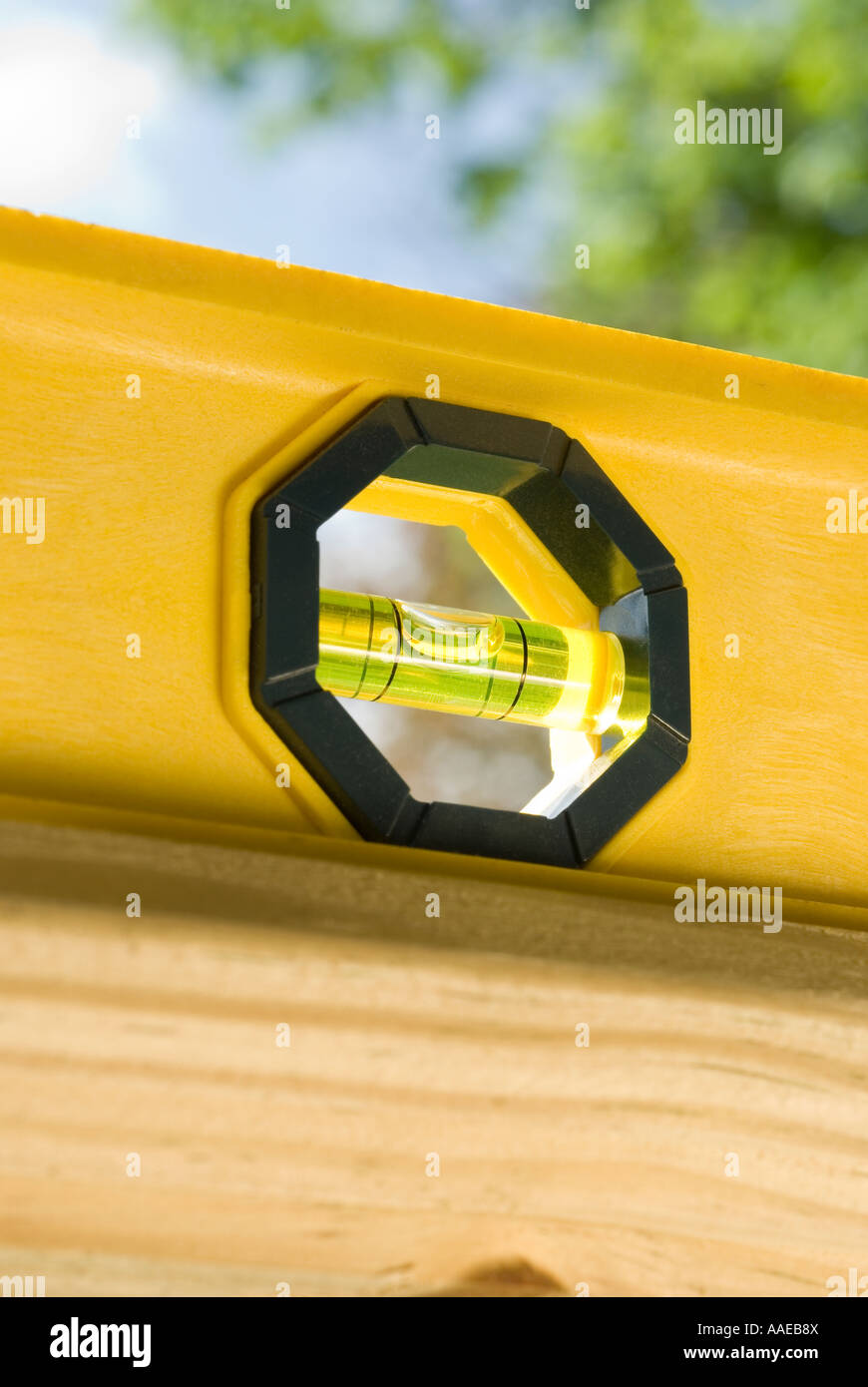 a yellow plastic builders level sits on top of a railing Stock Photo ...