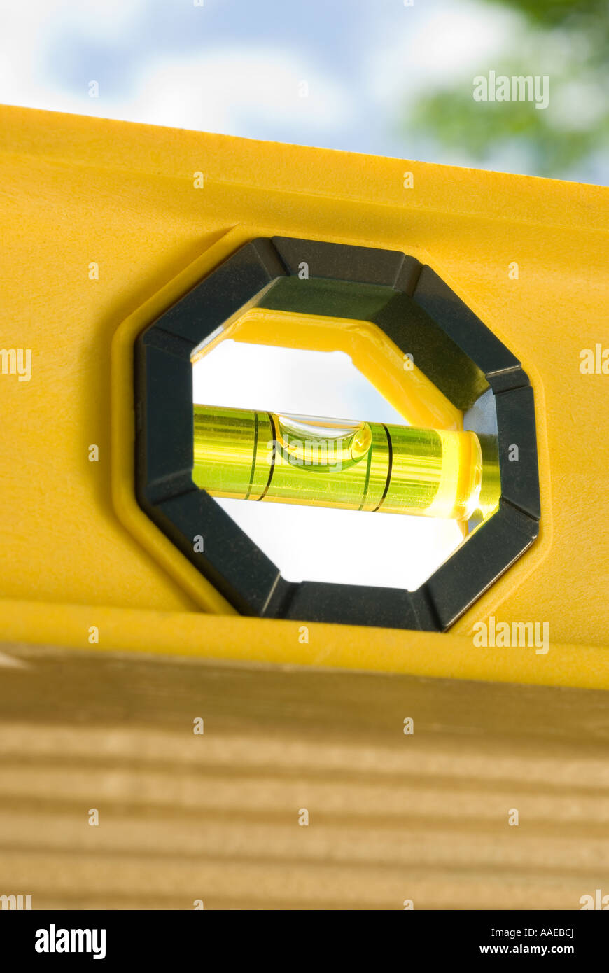 a yellow plastic builders level sits on top of a railing Stock Photo ...
