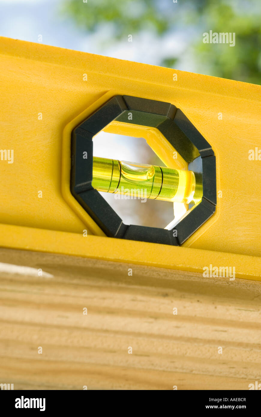 a yellow plastic builders level sits on top of a railing Stock Photo ...