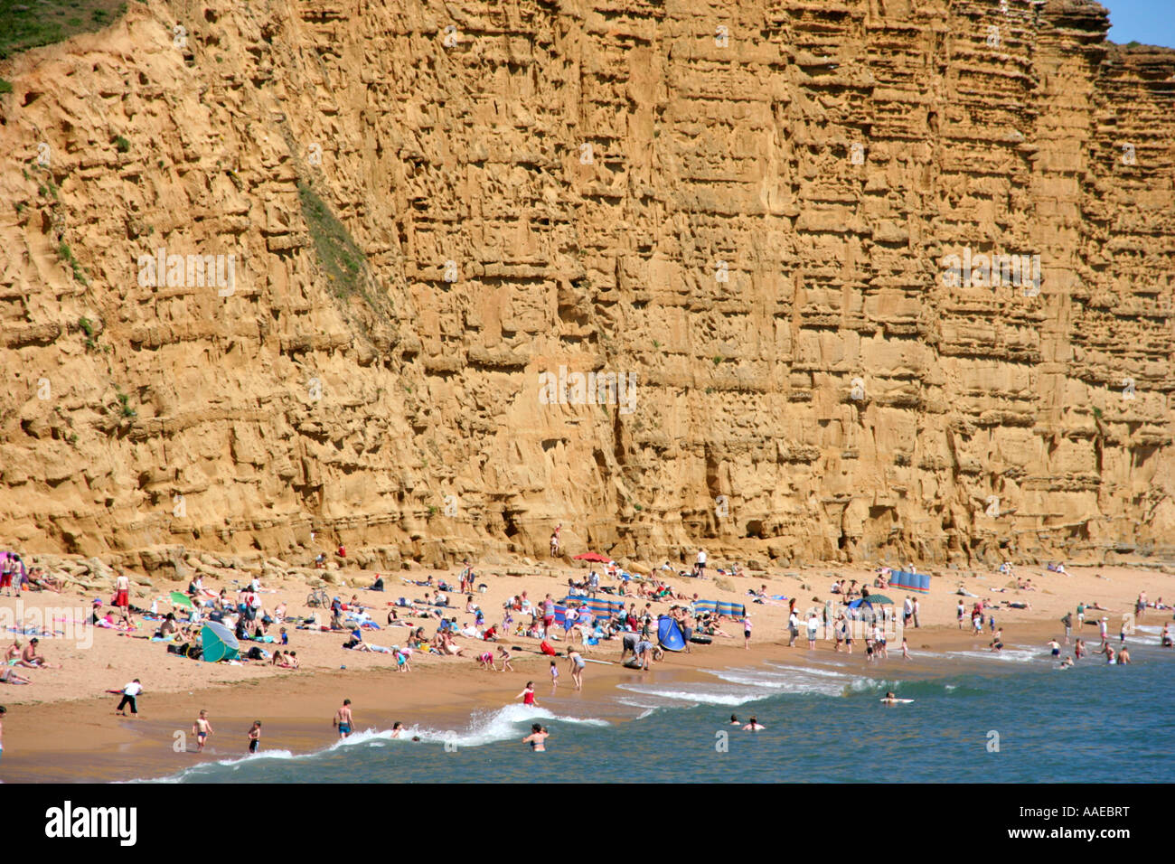 holidaymakers crowded beach west bay east sandstone cliff dorset ...