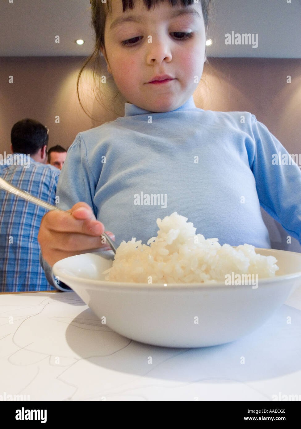 Four years old child eating rice Stock Photo - Alamy