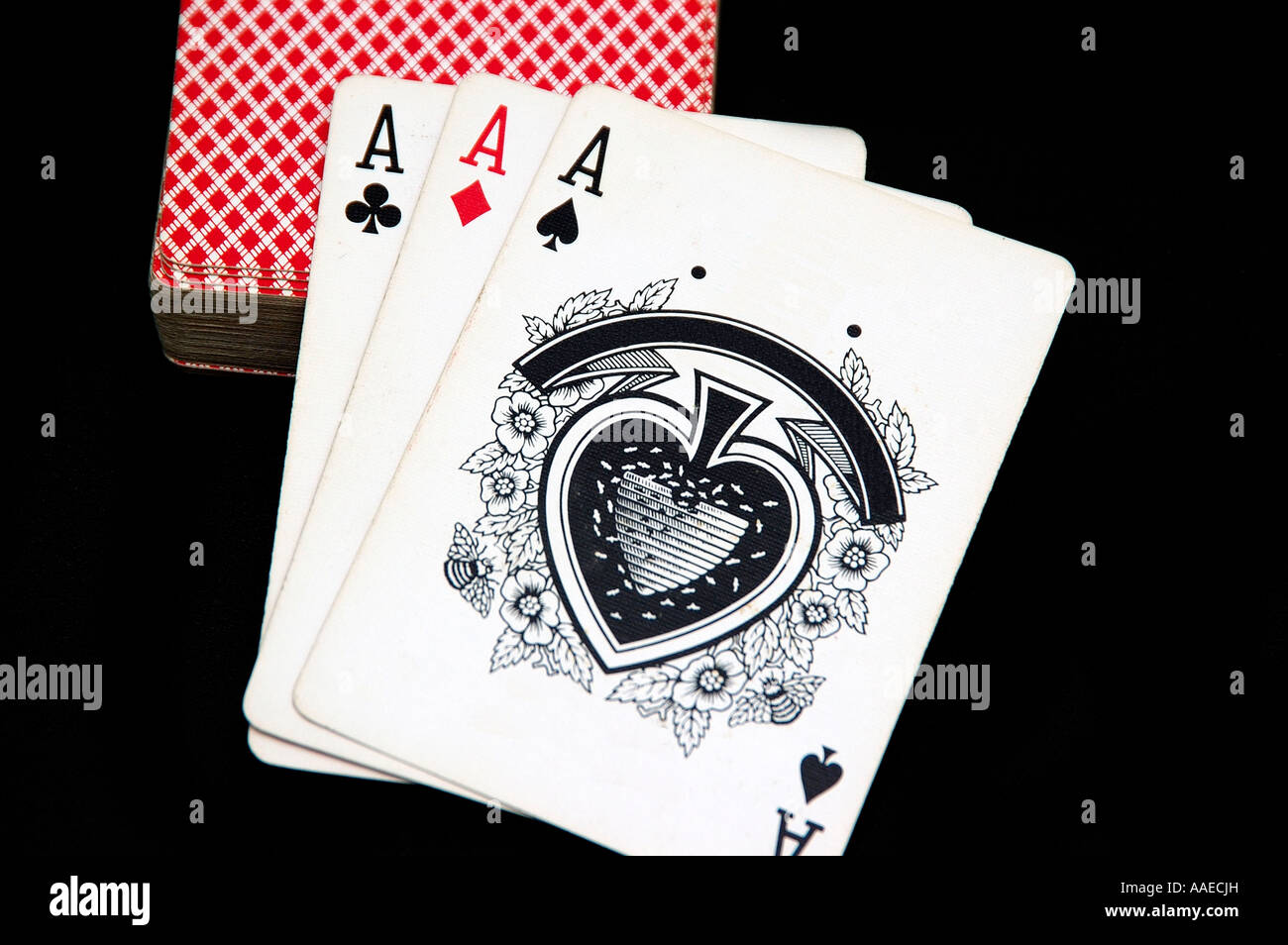 Three aces and a card deck on a black background Stock Photo - Alamy