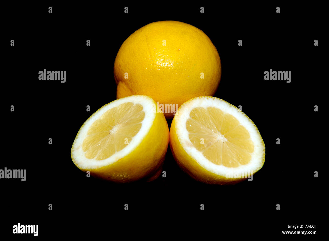 Cut and Whole lemon isolated in a dark background Stock Photo - Alamy