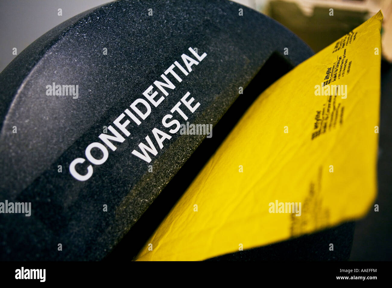 Confidential waste bin in office with package sticking out of it Stock ...