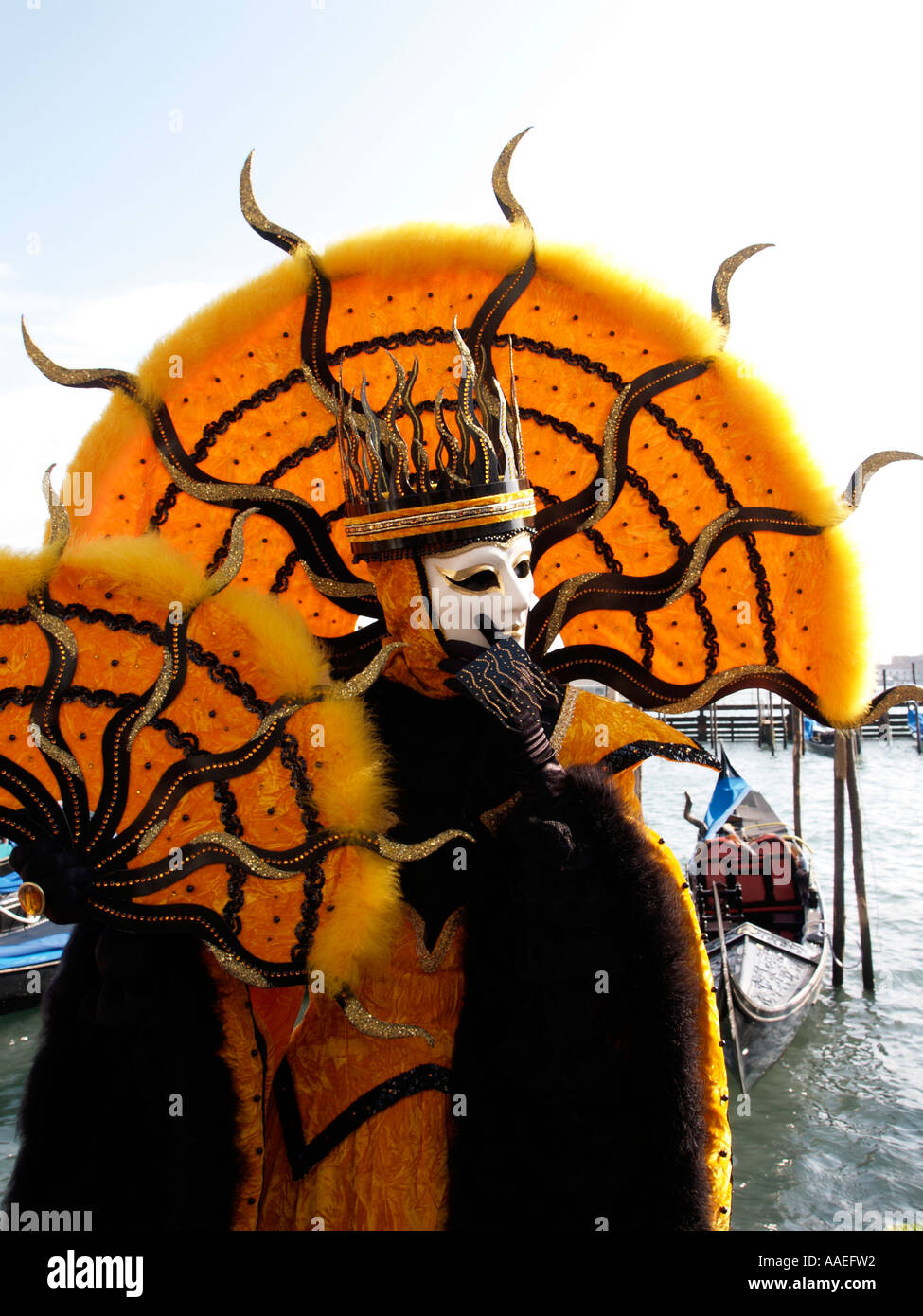 person in costume representing sun rays with hat and fan Venice ...