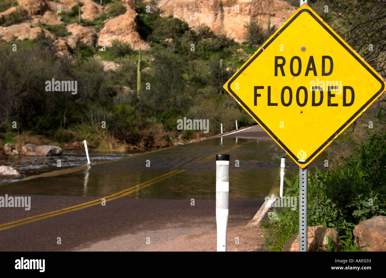 Caution sign by flooded road hi-res stock photography and images - Alamy
