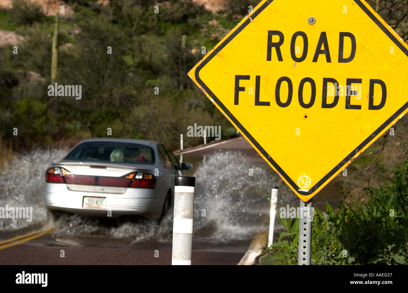 Vehicle driving on flooded road Stock Photo - Alamy