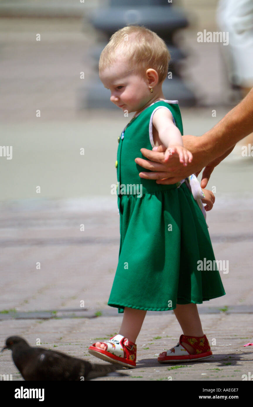 Father helping his daugter with first steps Stock Photo - Alamy