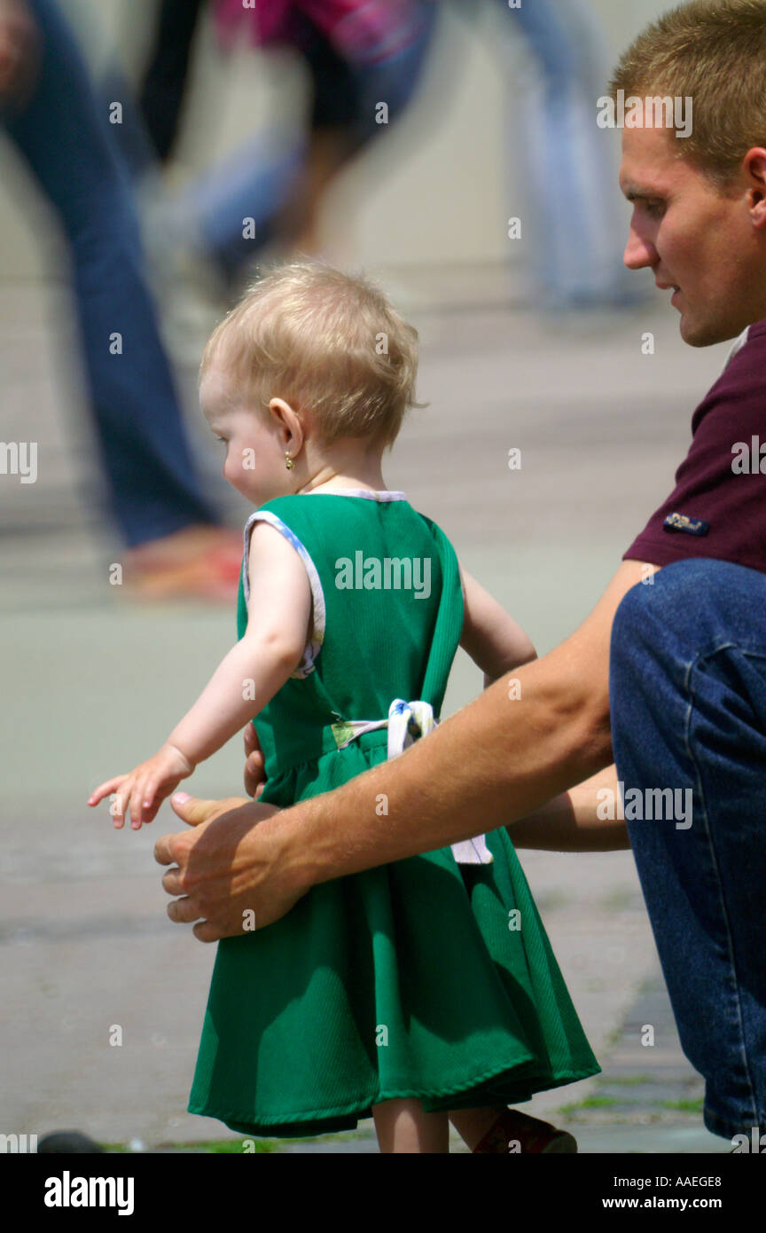 Father helping his daugter with first steps Stock Photo - Alamy