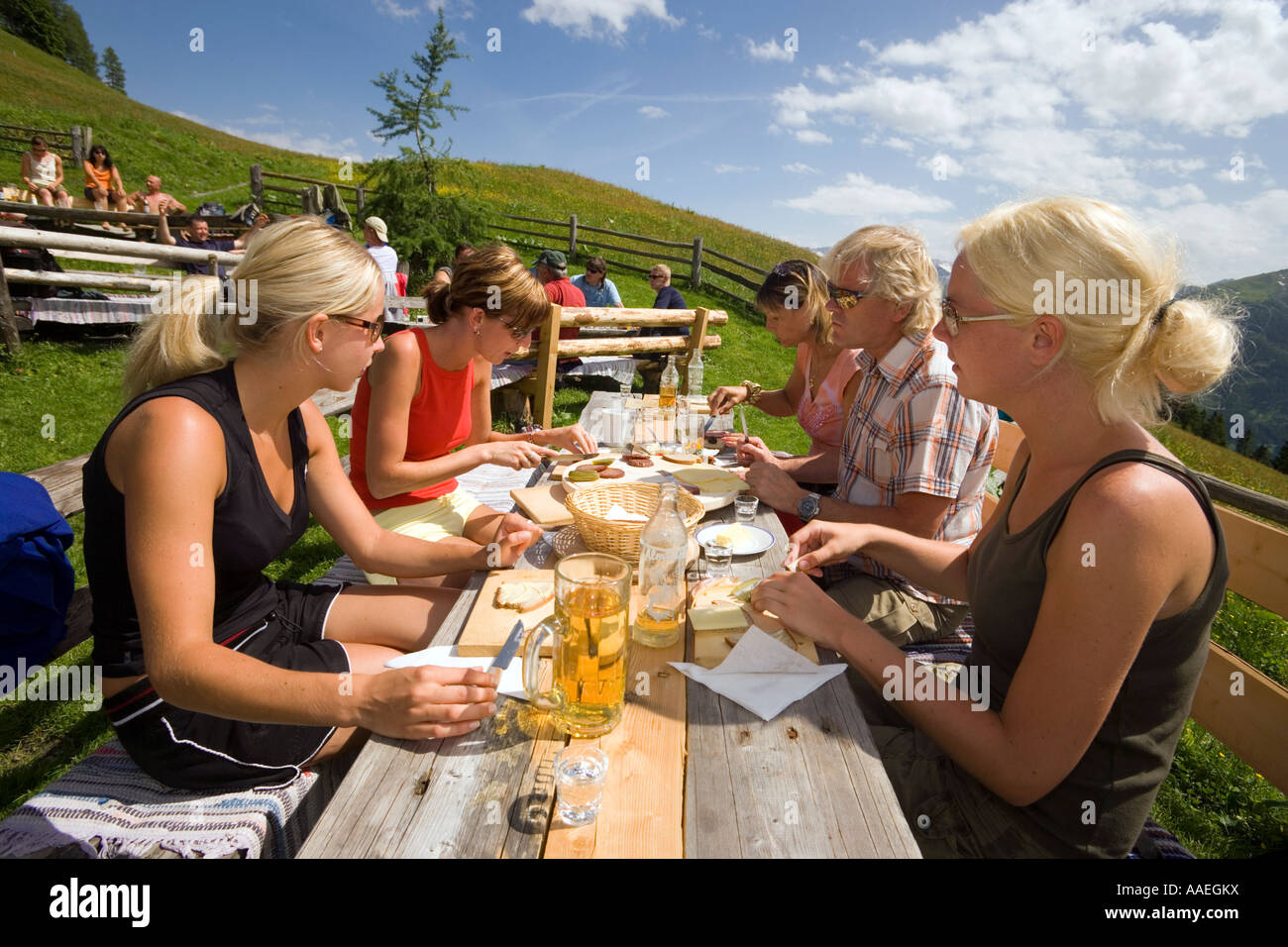 Tourists eating a Jause snack at Bichlalm 1731 m Grossarl Valley ...