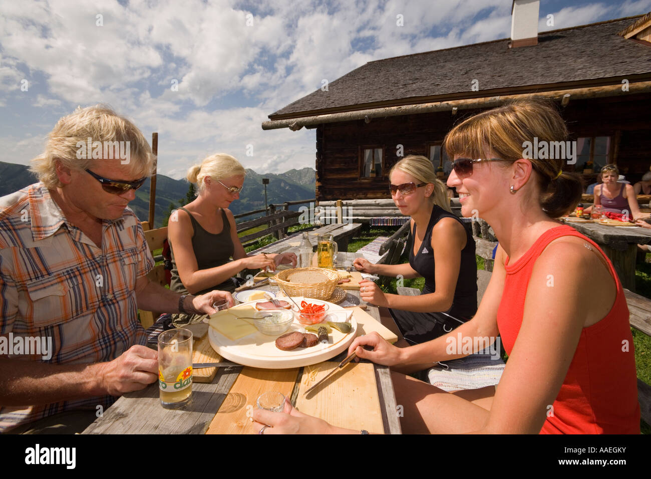 Tourists eating a Jause snack at Bichlalm 1731 m Grossarl Valley ...