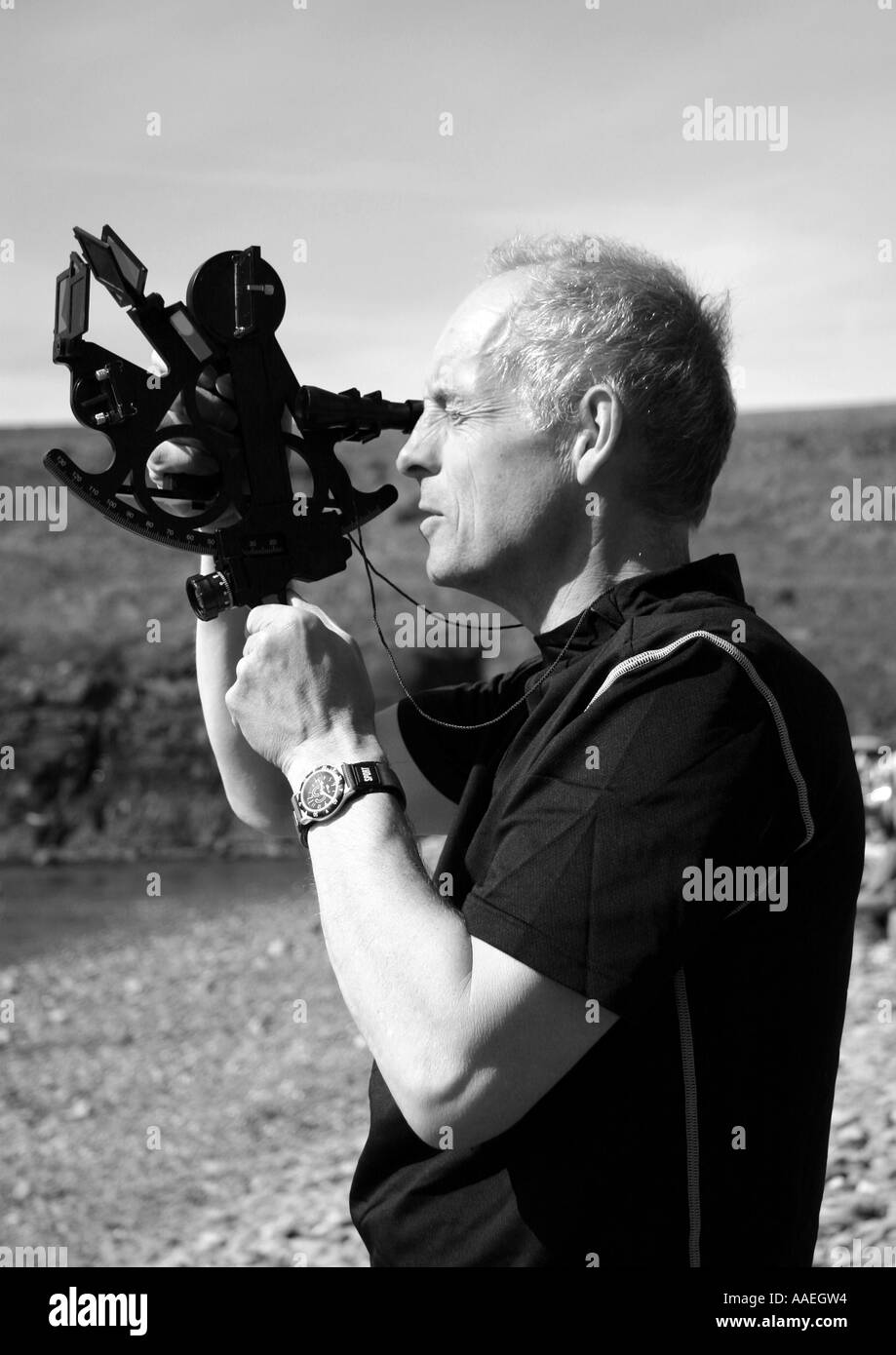 Man looking through a sexton Stock Photo - Alamy