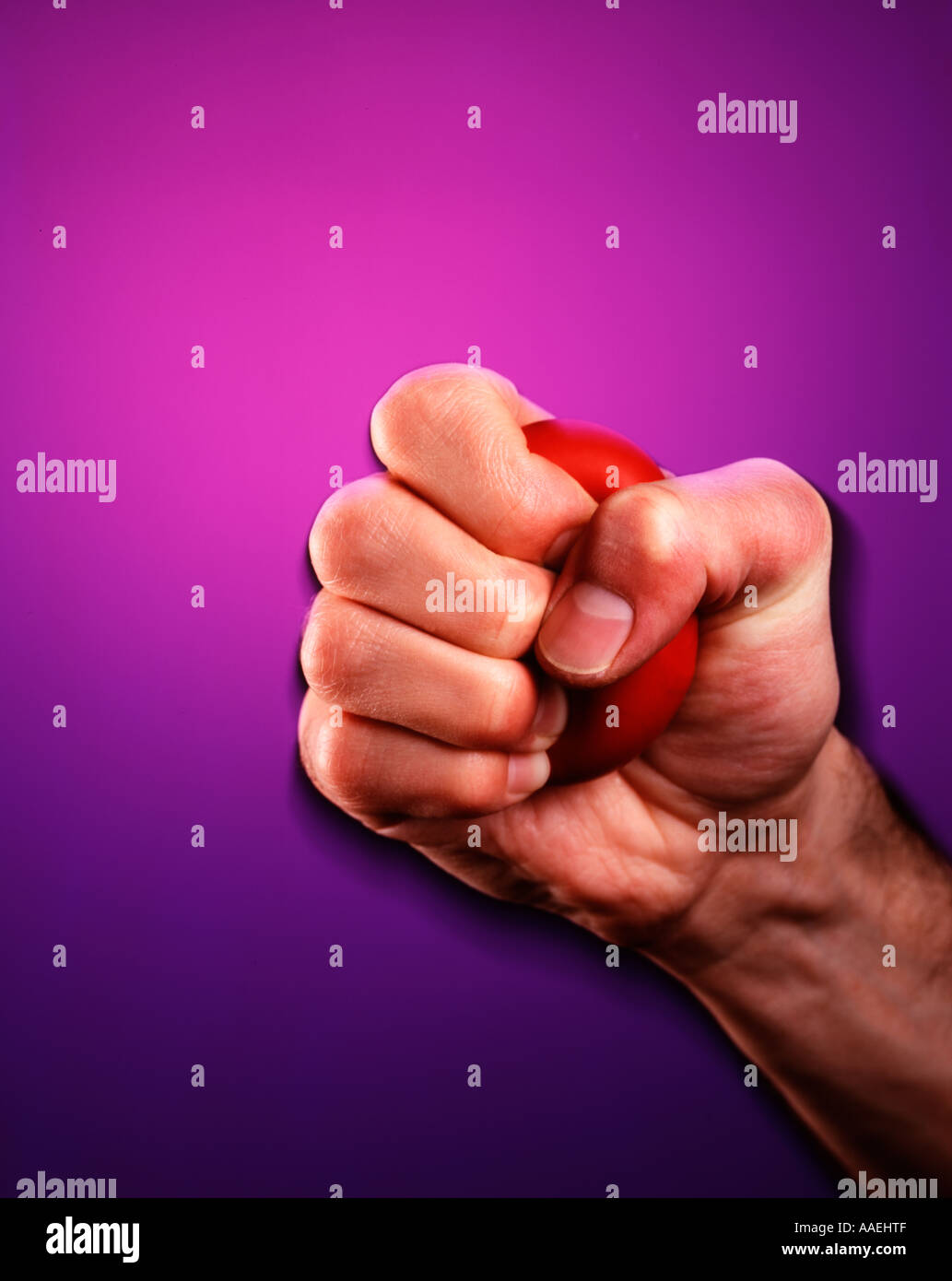 hand squeezing red stress ball Stock Photo - Alamy