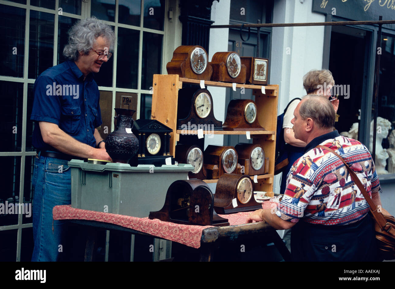 Buying antique clocks on Portobello Flea Market London Stock Photo - Alamy