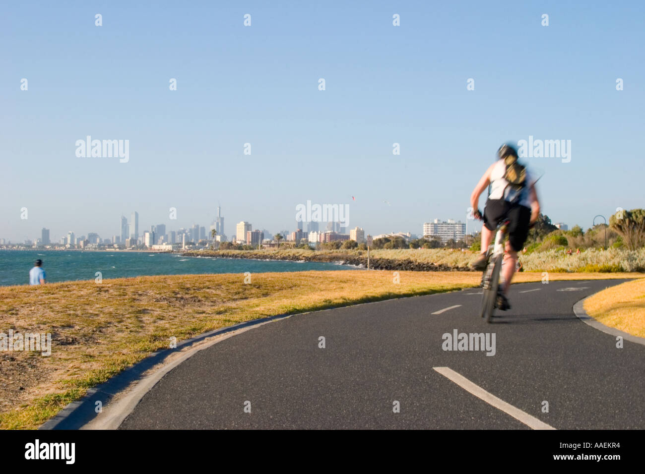 Cyclist speeding by on cycle track with Melbourne skyline in background ...