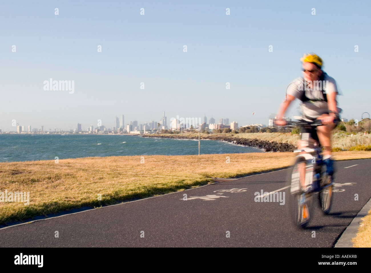 Cyclist speeding by on cycle track with Melbourne skyline in background ...