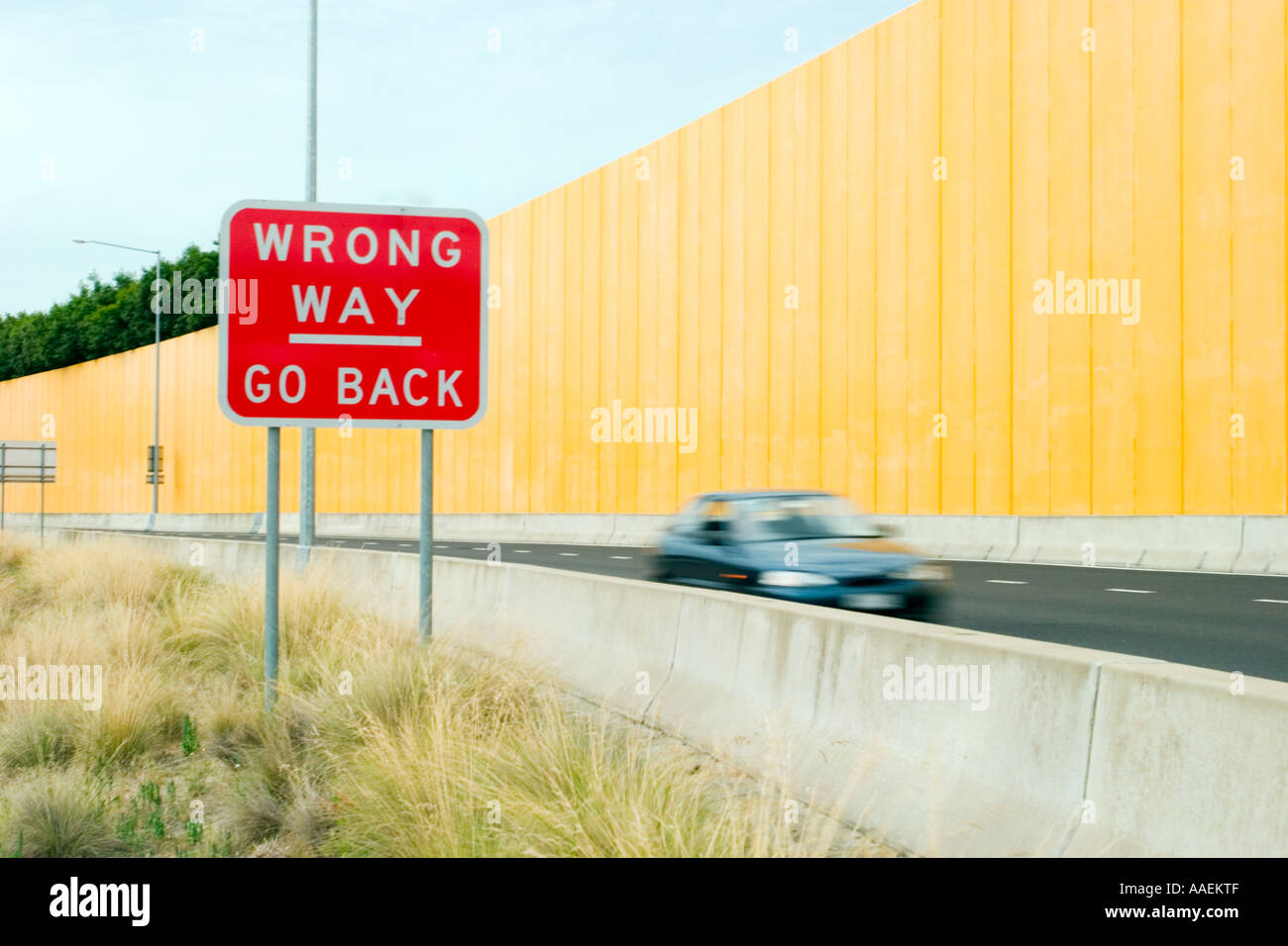 Wrong way turn back red road sign and advancing blurred car Melbourne ...