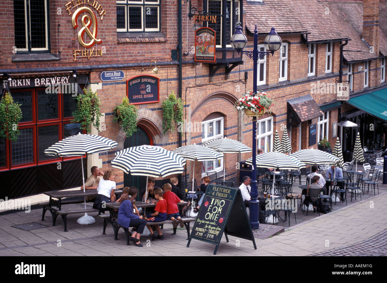 People sitting in outdoor area of pubs at castle road Nottingham ...