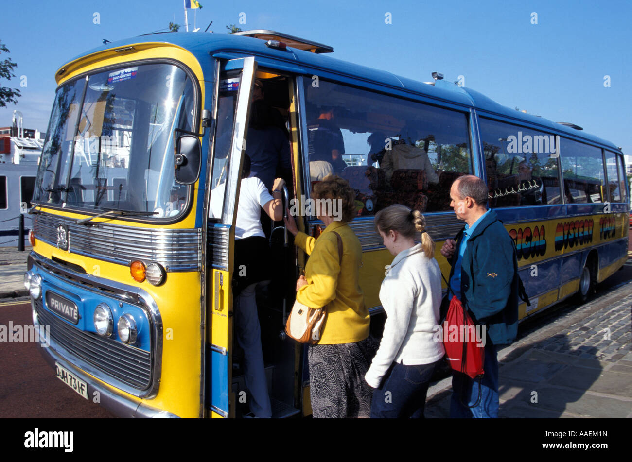 Tourists entering a bus Beatles Magic Mystery Tour Liverpool Merseyside ...