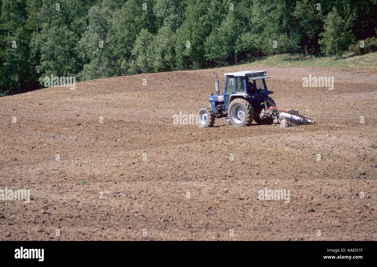 Tractor ploughing hillside Norway Stock Photo - Alamy