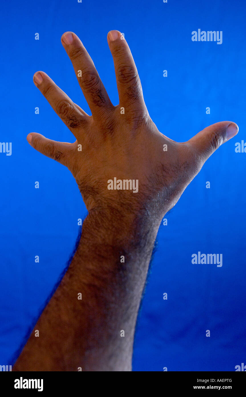 Hand on blue background Stock Photo - Alamy