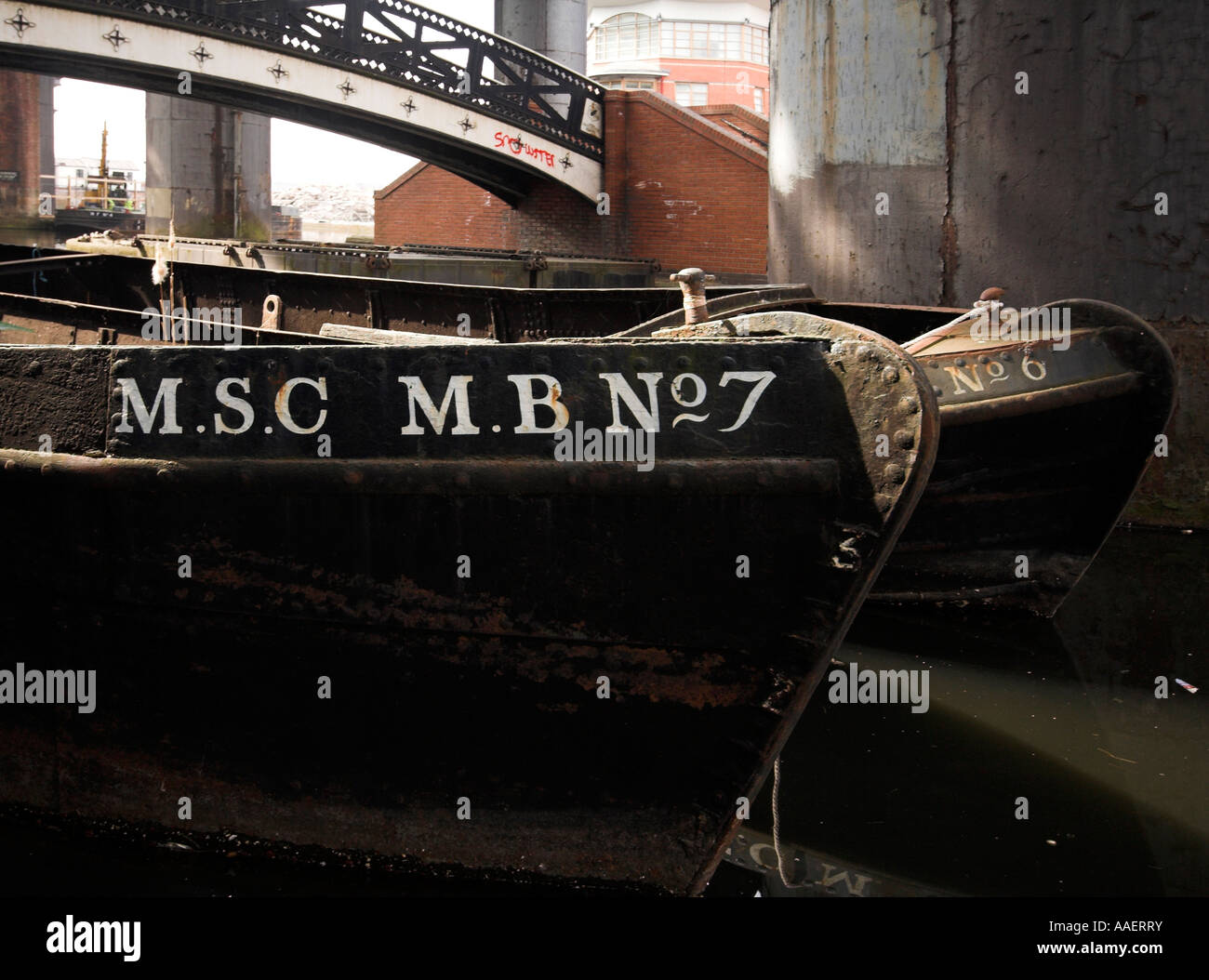 Barge underneath a Victorian railway bridge, Castlefield, Manchester ...