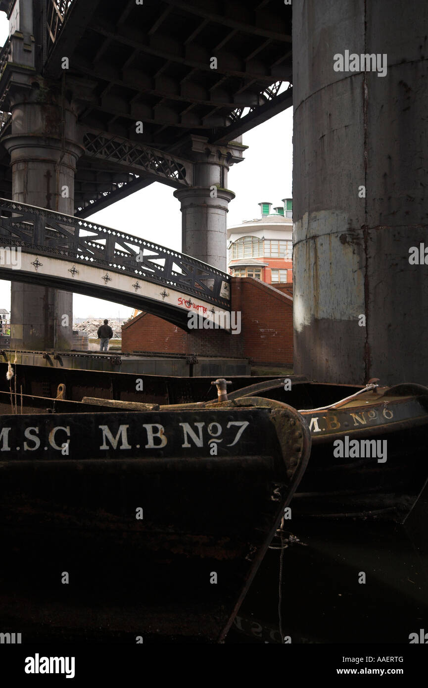 Barge underneath a Victorian railway bridge, Castlefield, Manchester ...
