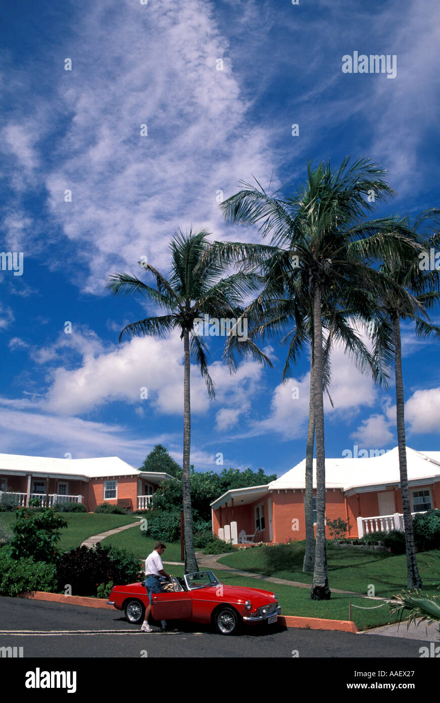 Bermuda Ariel Sands Resort pink buildings palm trees blue sky ...