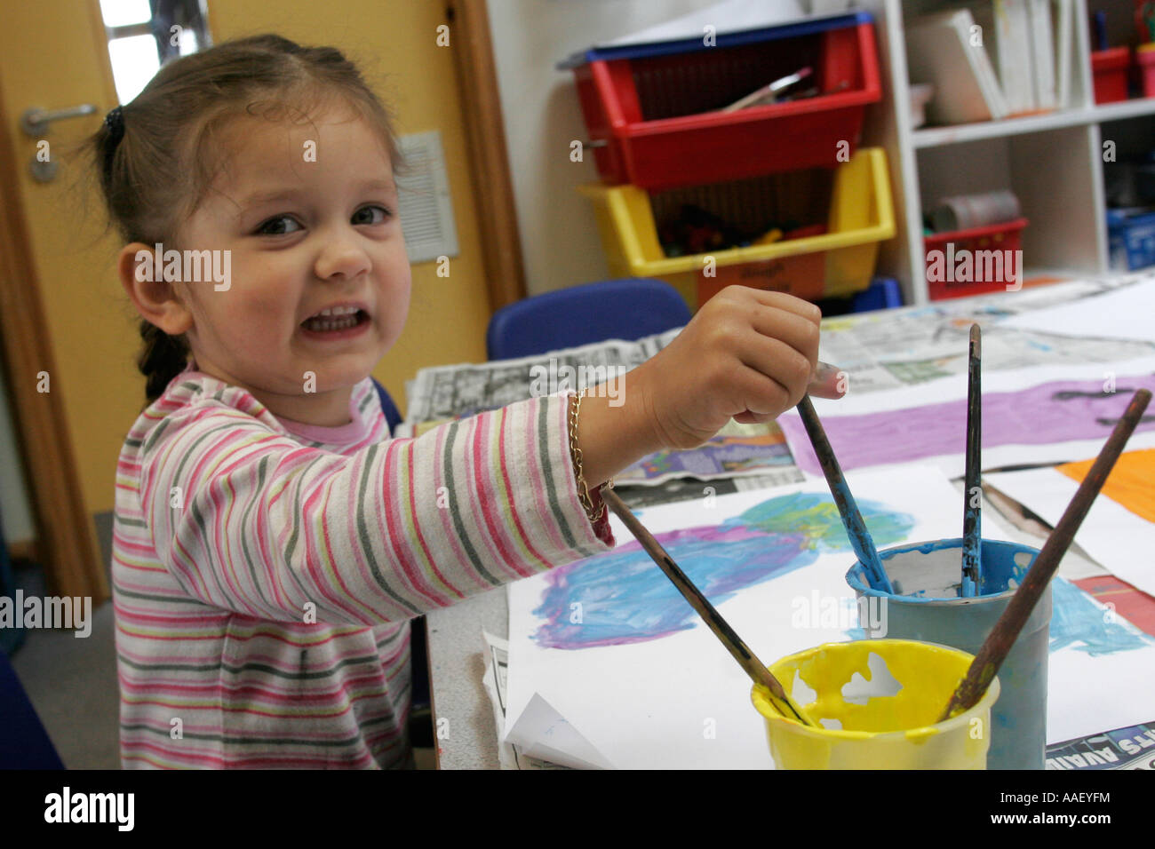 Primary school girl in art class painting Stock Photo - Alamy