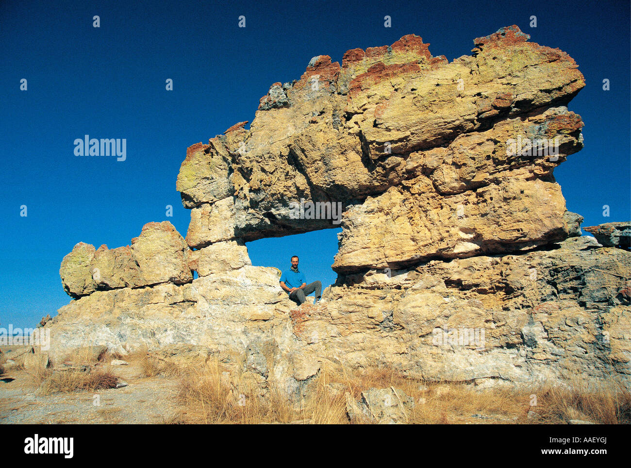 Tourist at La Fenetre natural rock window Isalo National Park Southern ...