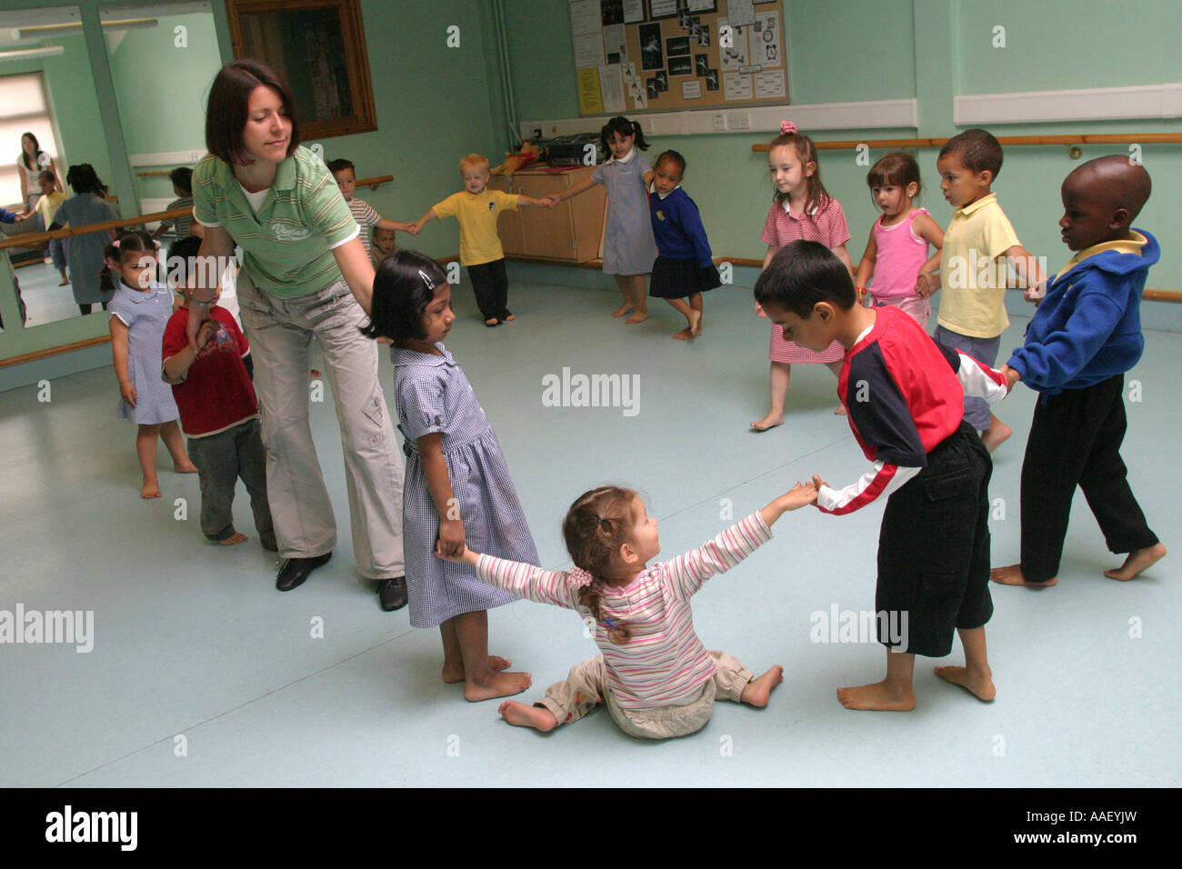 Primary school teacher with class in group activity Stock Photo - Alamy