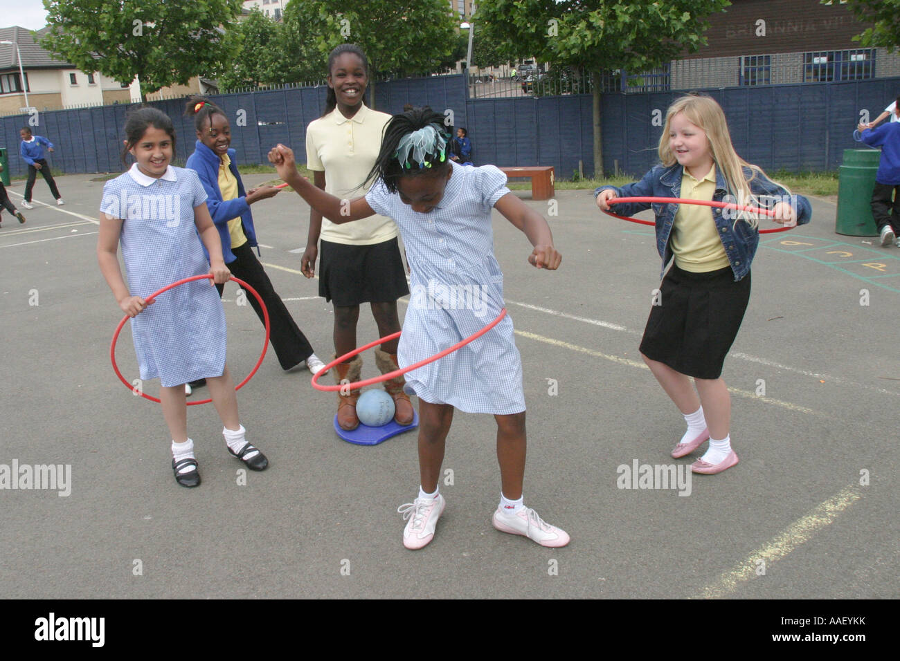 Primary school children play in playground during break from lessons ...