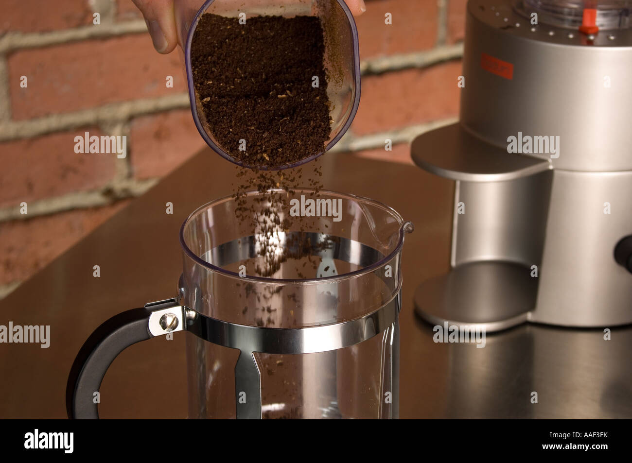 Pouring ground coffee into a french press coffee pot Stock Photo - Alamy