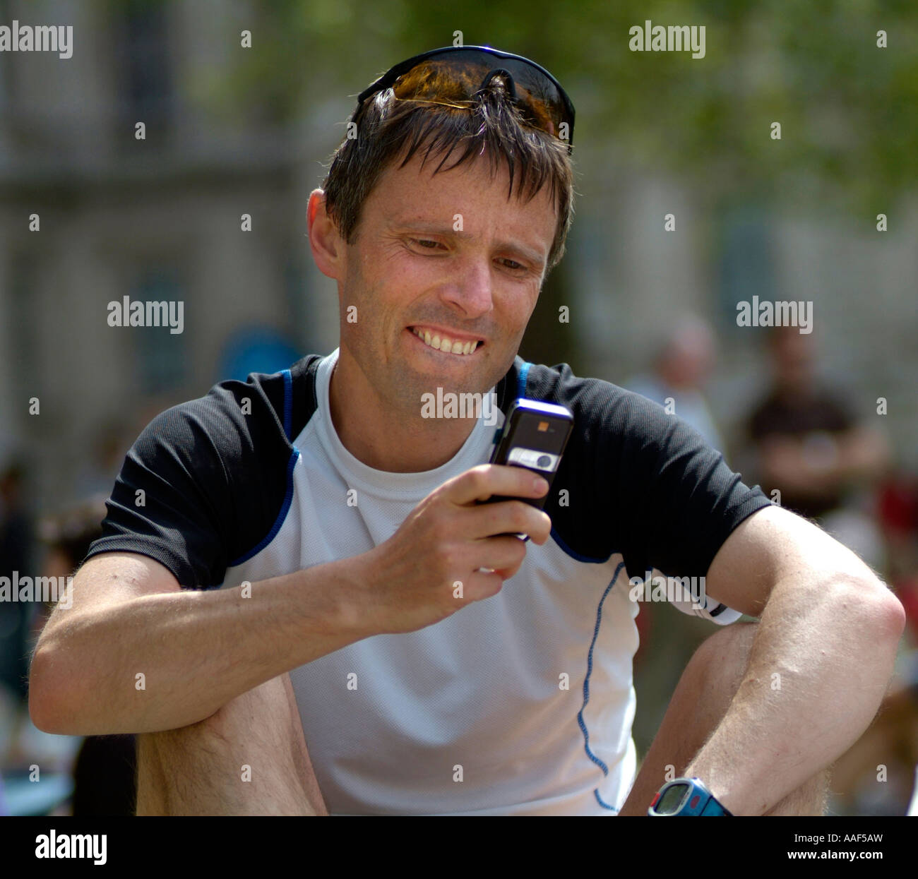 man looking at mobile telephone Stock Photo - Alamy