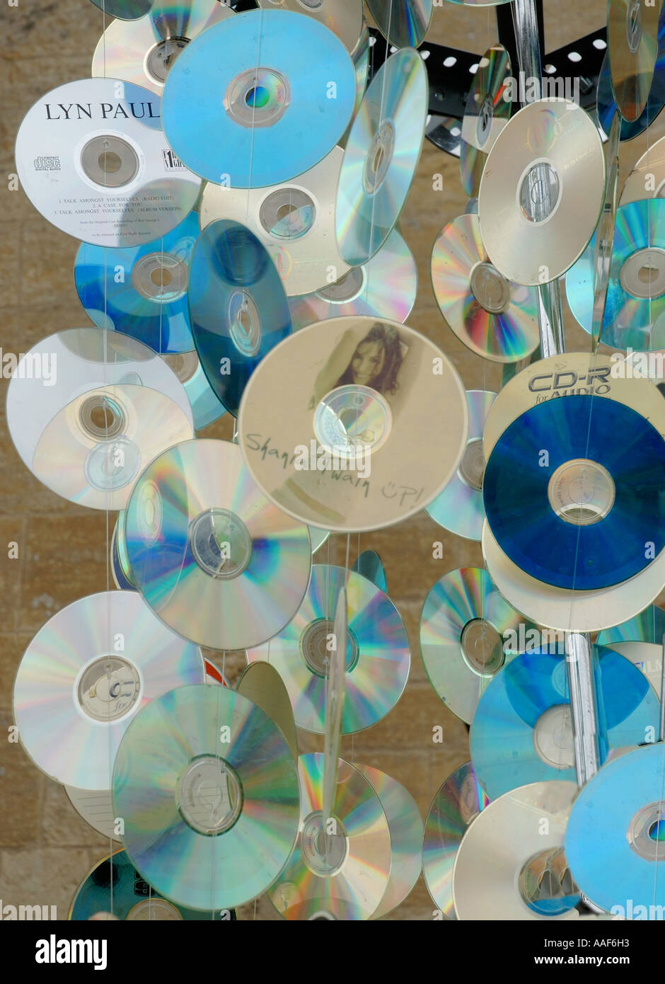 CD discs hanging from a display in a decorative art form Stock Photo ...