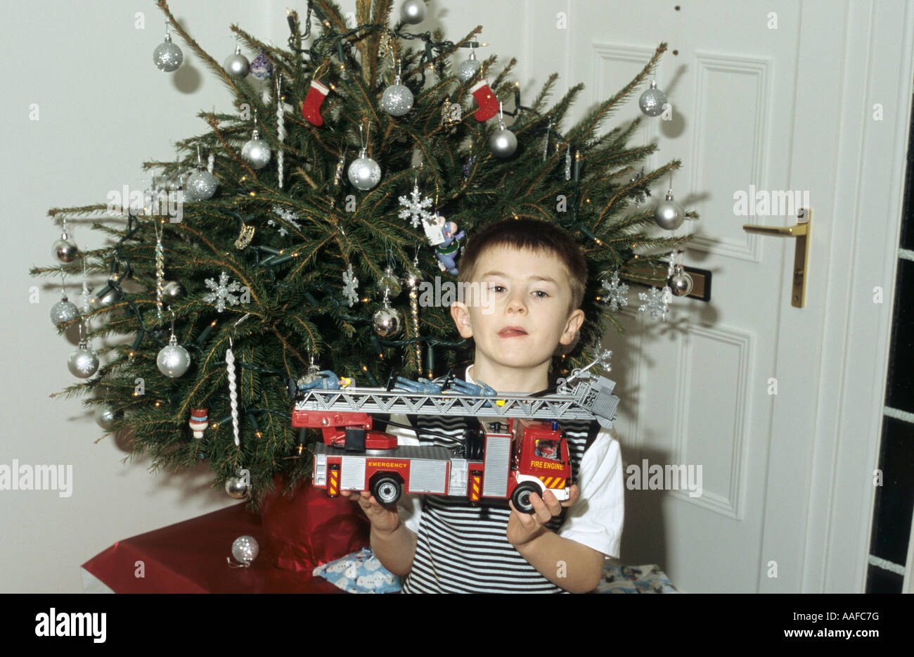 Boy With Fire Engine Toy On Christmas Day in the Uk Stock Photo - Alamy