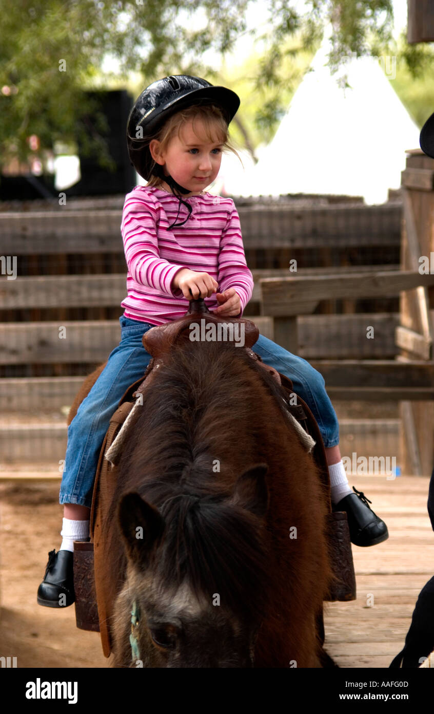 Girl on pony ride Stock Photo - Alamy