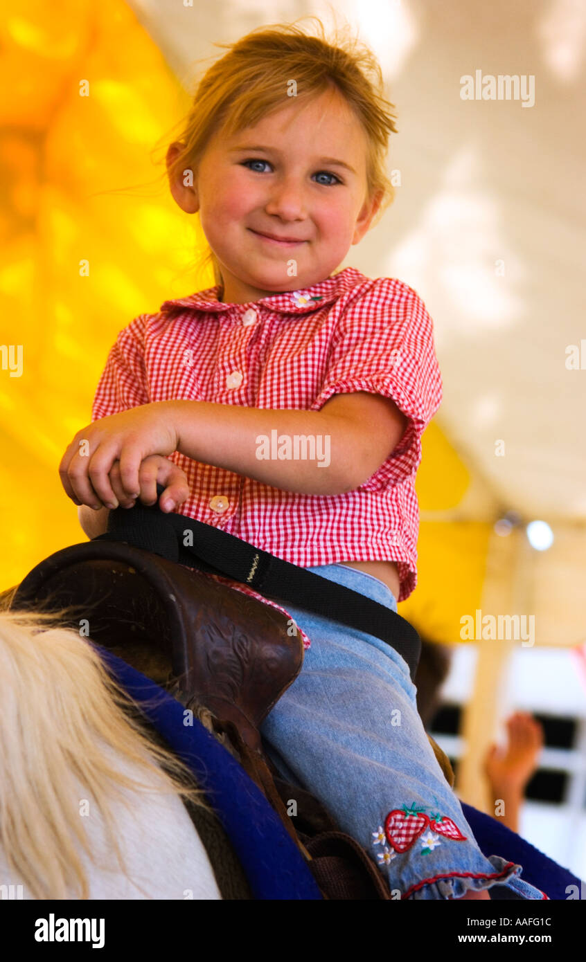 Girl on pony ride Stock Photo - Alamy