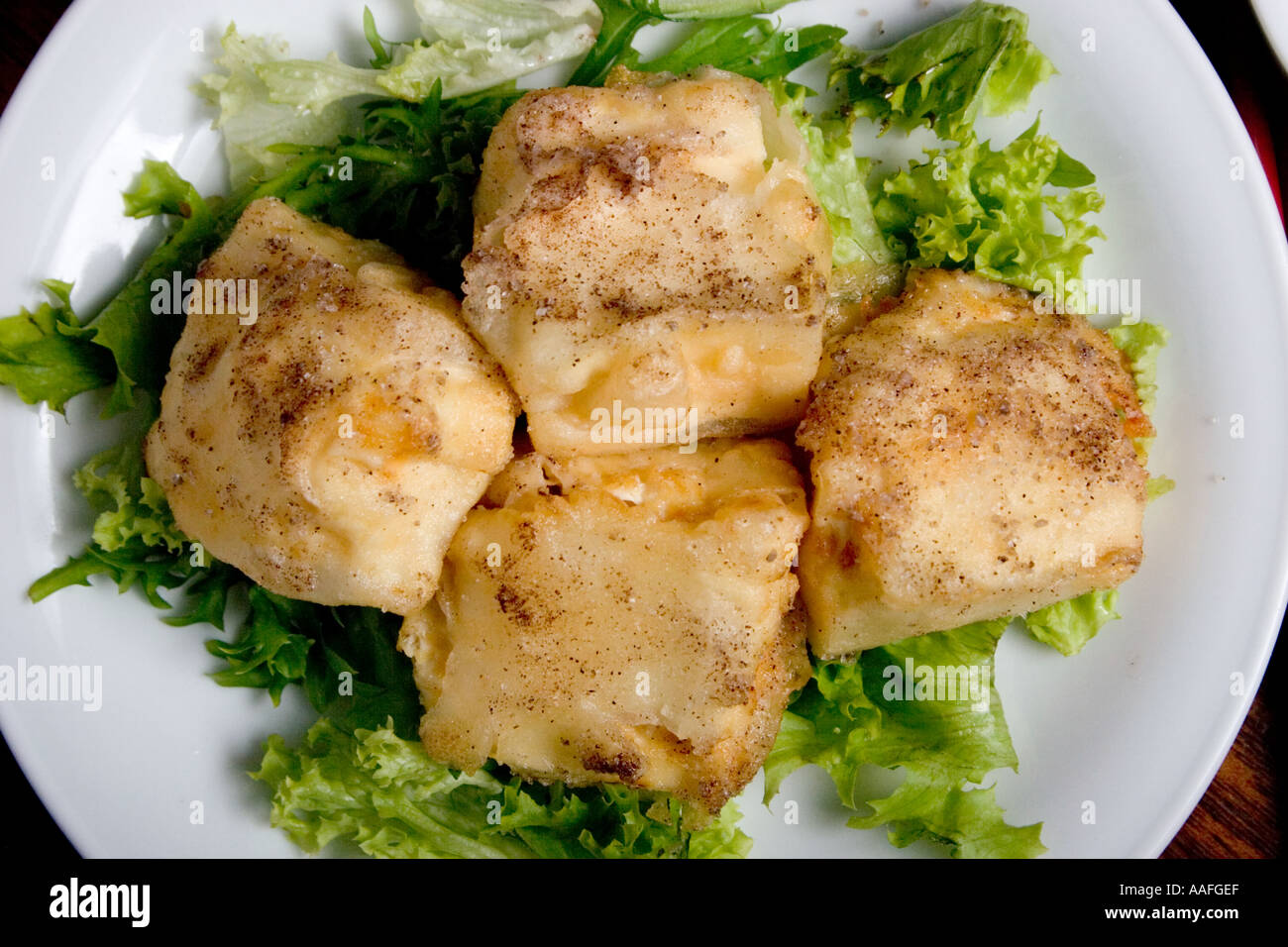 Deep fried bean curd with spiced salt on a bed of lettuce Stock Photo ...