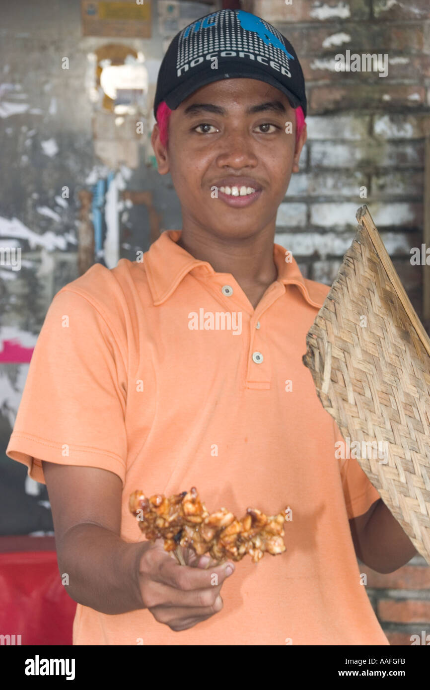 Boy with satay sticks in a Jakarta streetside food stall Stock Photo ...