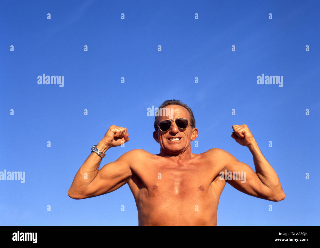 senior man flexing muscles Stock Photo - Alamy