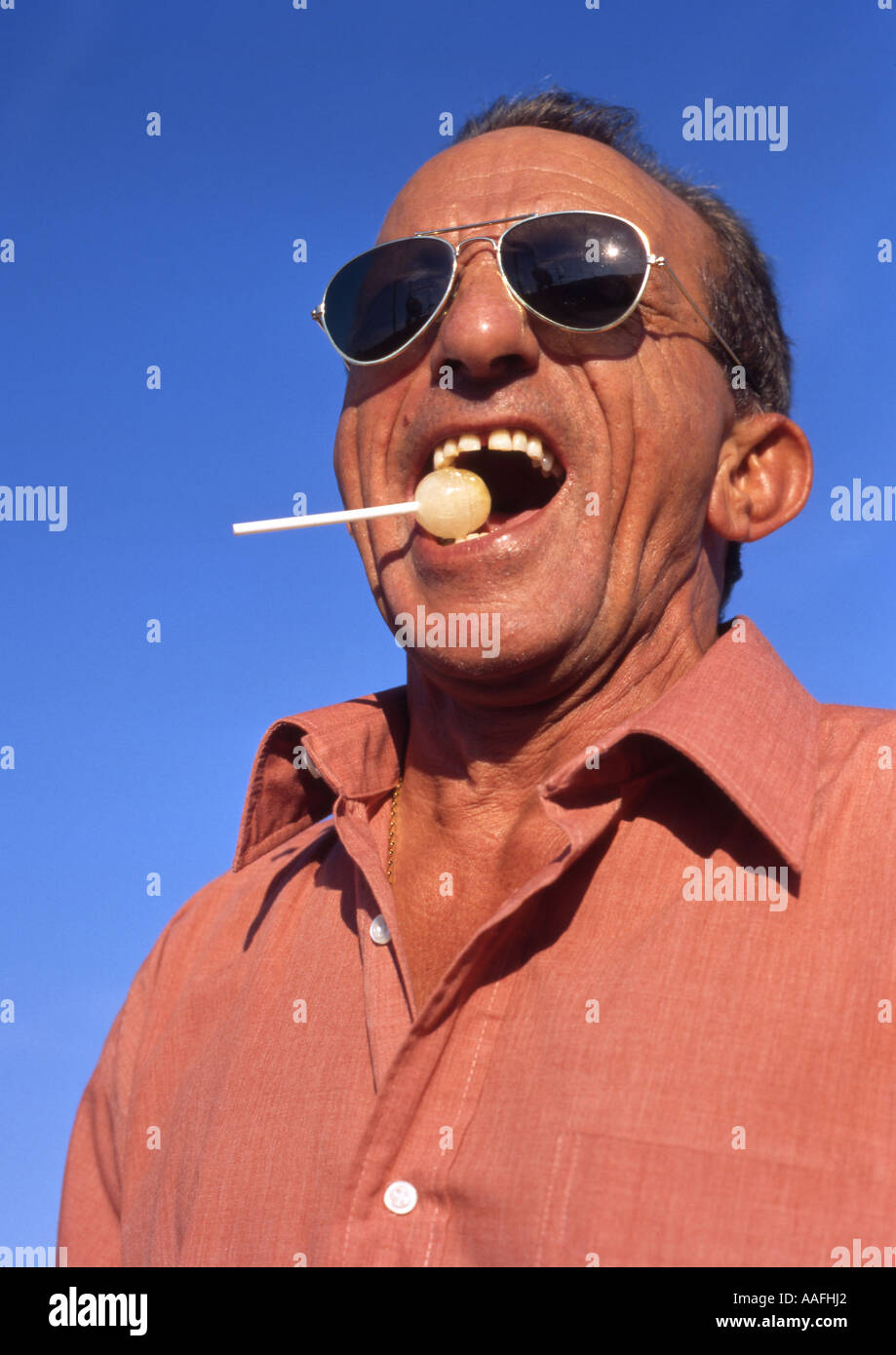 senior man munching lollipop Stock Photo - Alamy