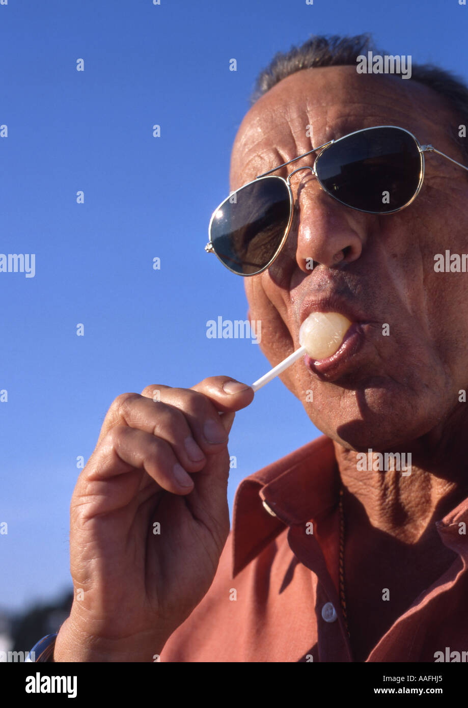 senior man munching lollipop Stock Photo - Alamy