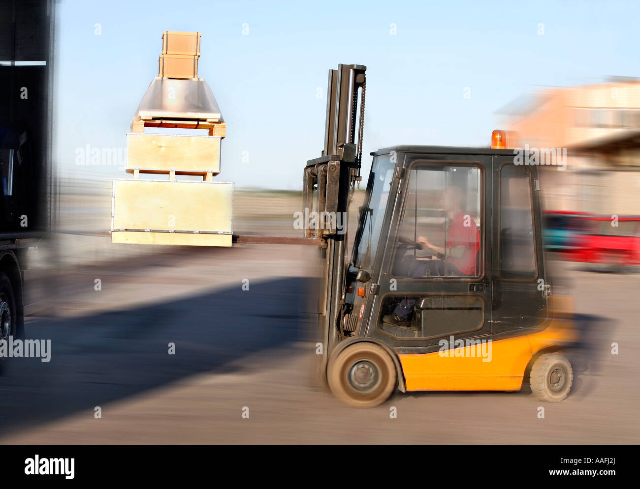 Forklift loading truck Stock Photo - Alamy