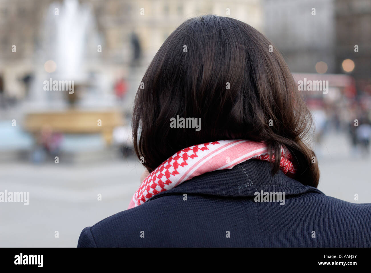 Rear view of student wearing red arab scarf Stock Photo - Alamy